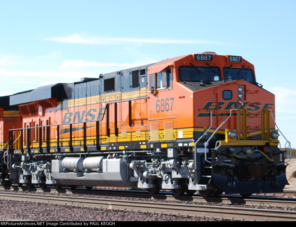 Zoomin shot of BNSF 6867 as she rolls west with BNSF 6866 as the DPU.